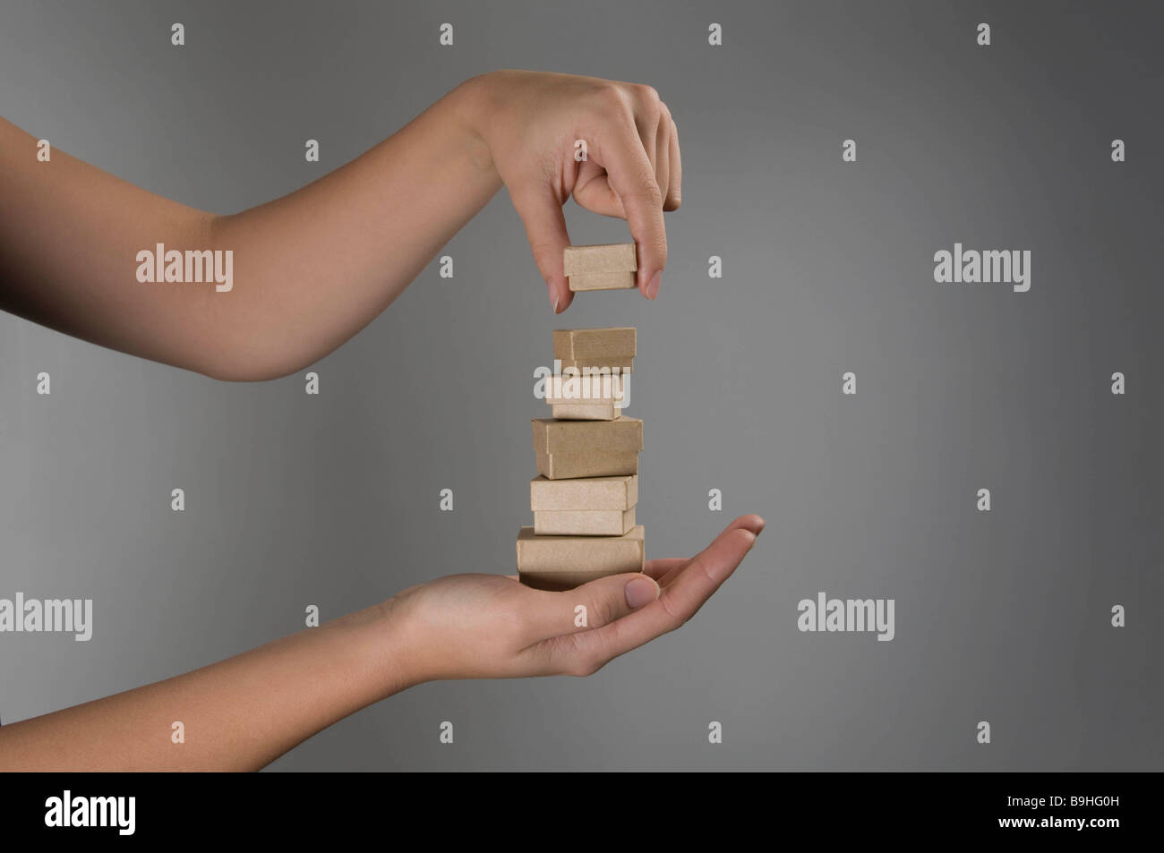 Female hands holding pile of small boxes Stock Photo - Alamy