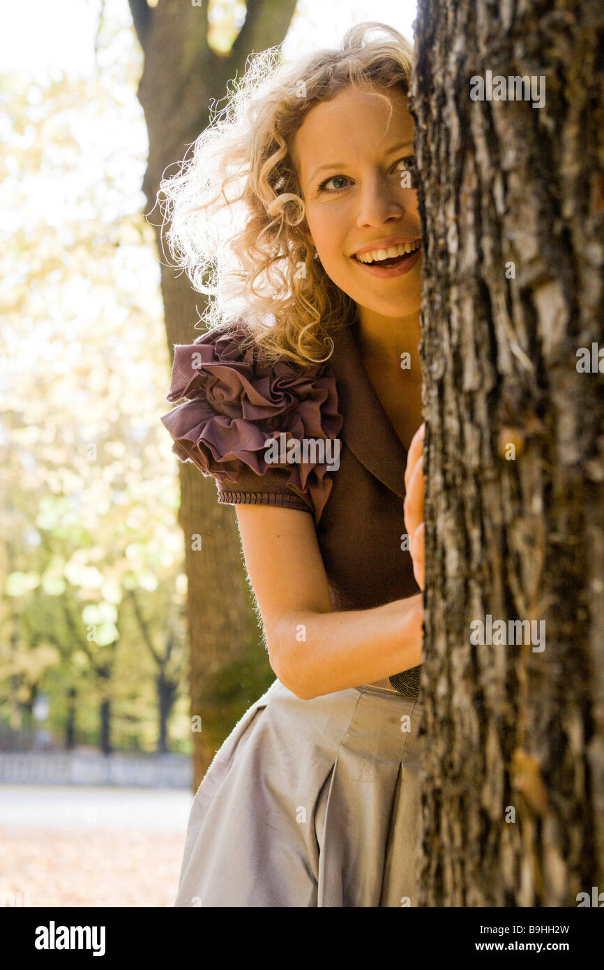 Watching behind tree hi-res stock photography and images - Alamy