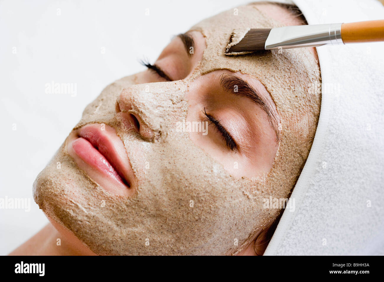 Woman getting face mask Stock Photo - Alamy