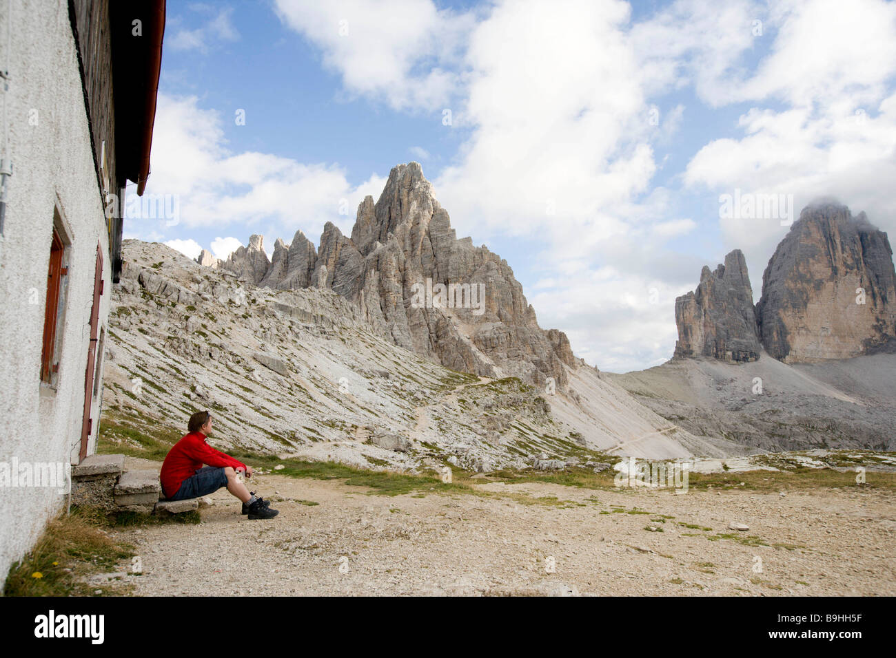 Man sitting on door step looking up Stock Photo - Alamy