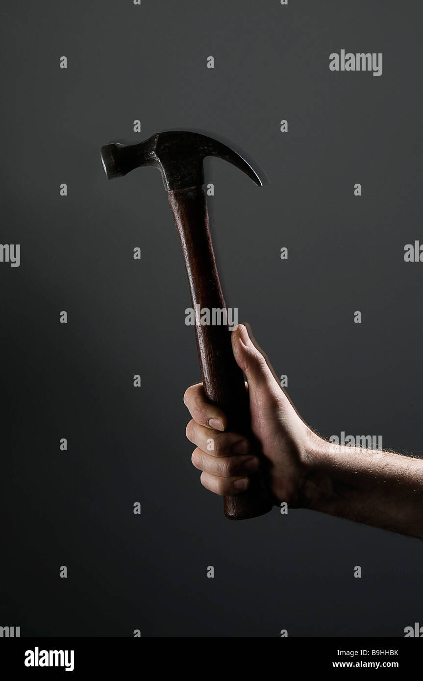 Female hand holding a hammer Stock Photo - Alamy