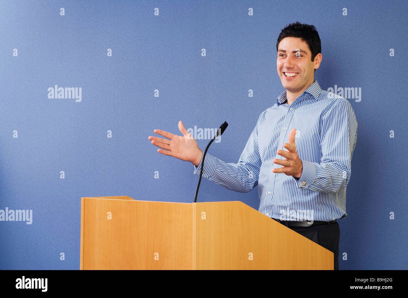 Man talking from lectern Stock Photo - Alamy