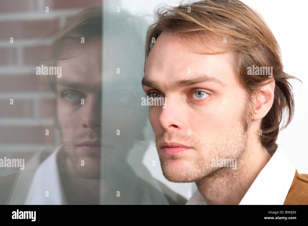 Windows man young seriously out-looks lost in thought portrait people ...