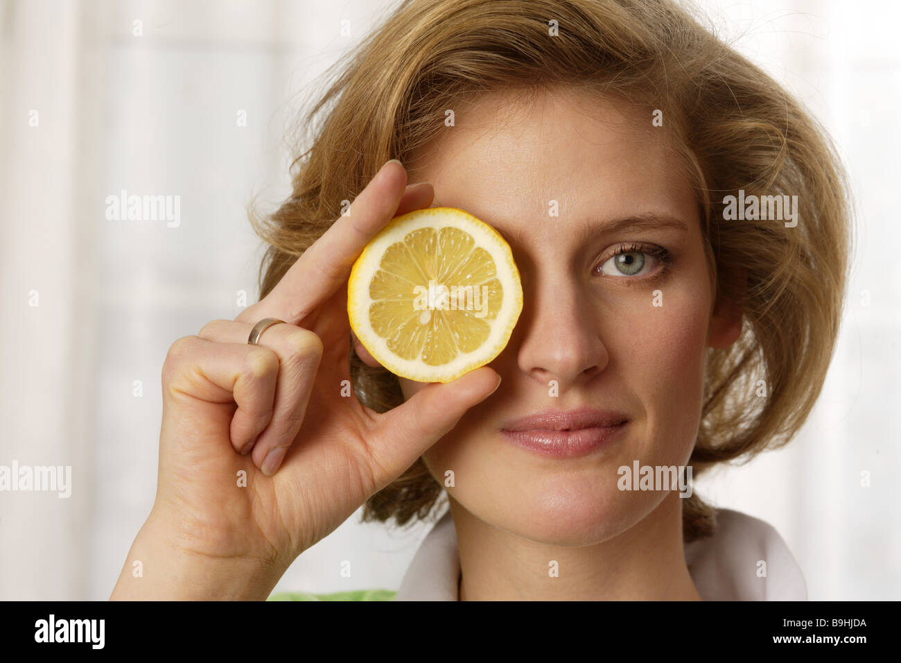 Woman lemon slice eye lasts portrait Stock Photo - Alamy