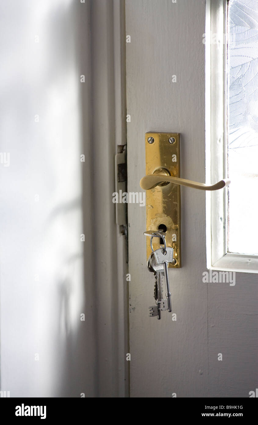 Keys in lock of white painted glass panel door portrait view Stock ...