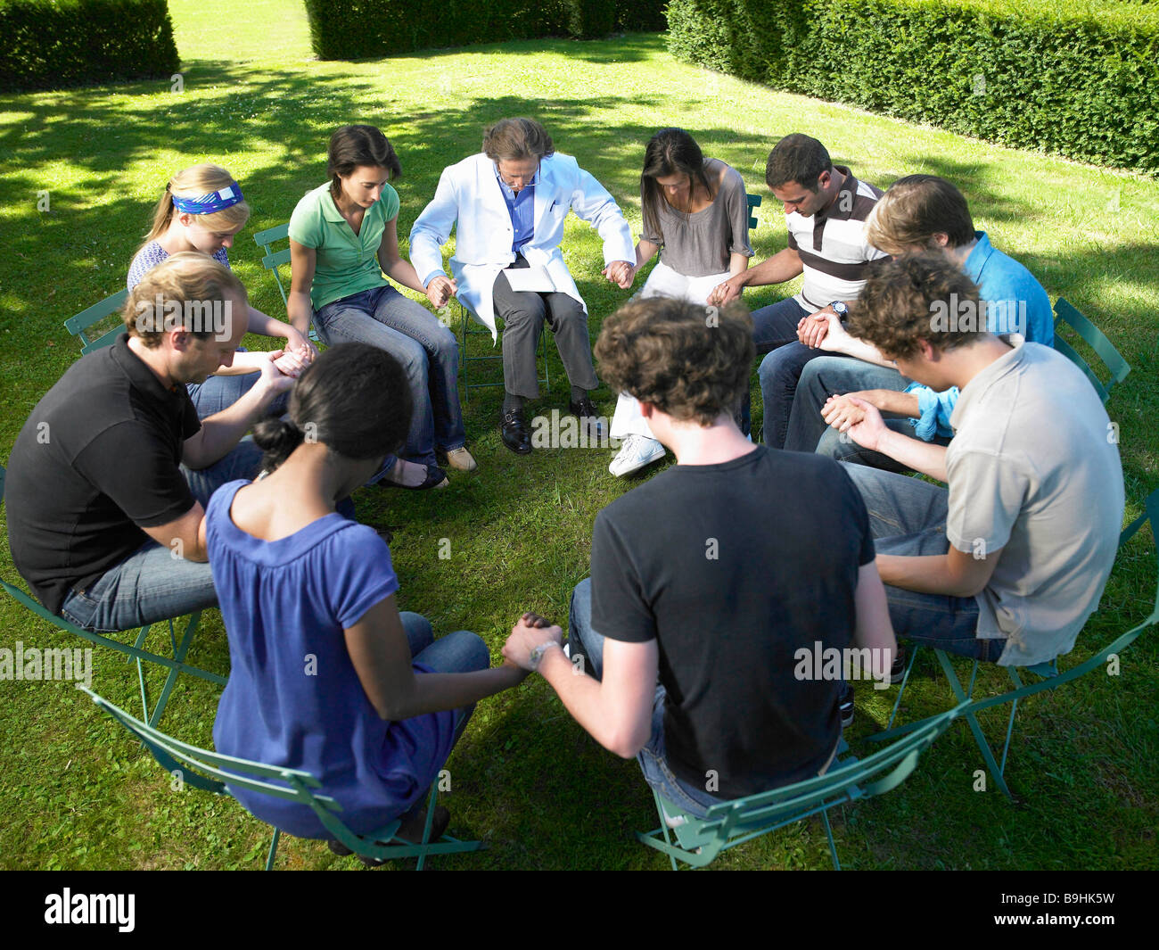 Circle of people in rehab, holding hands Stock Photo - Alamy