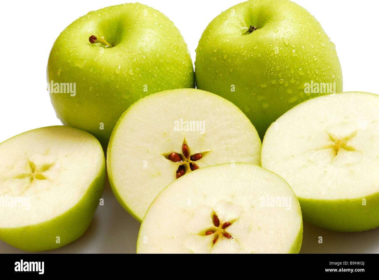 Apples, cut into halves and whole Stock Photo - Alamy