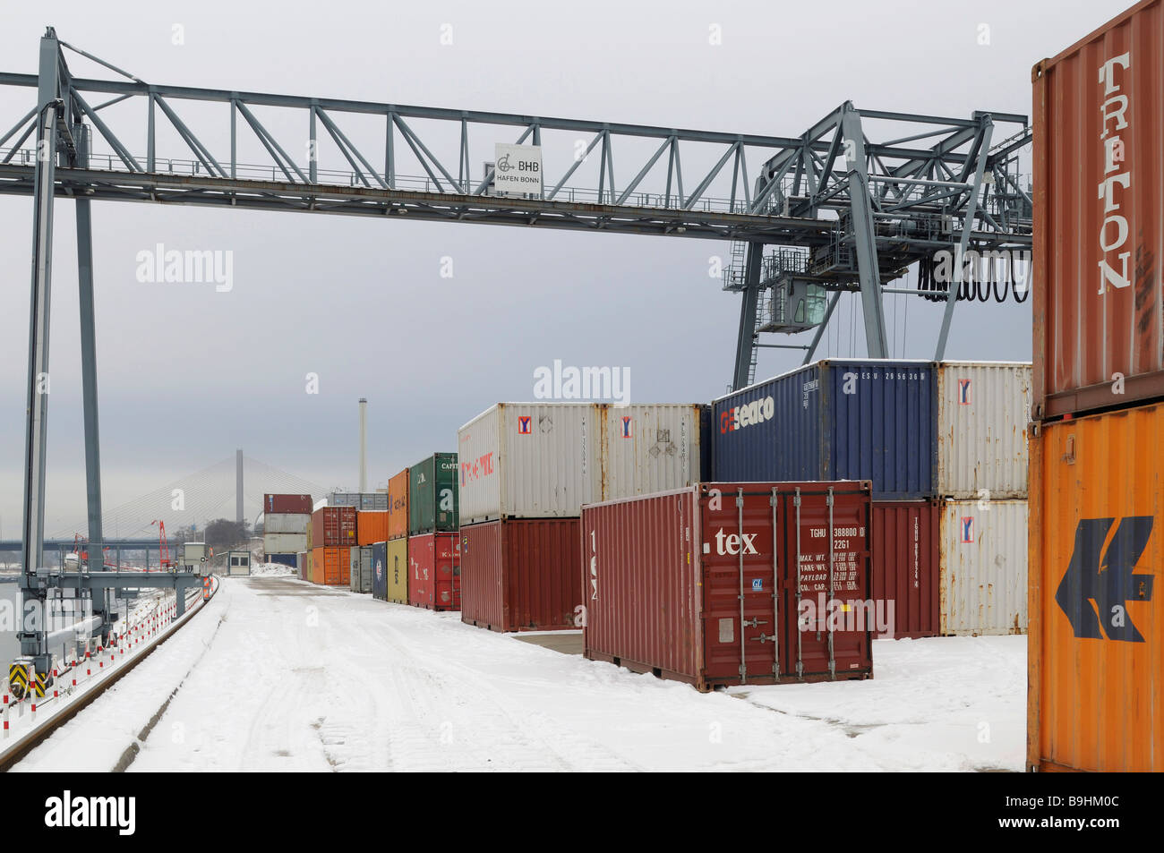 Winter at Bonn Harbour, snow-covered quay, view of container terminal ...