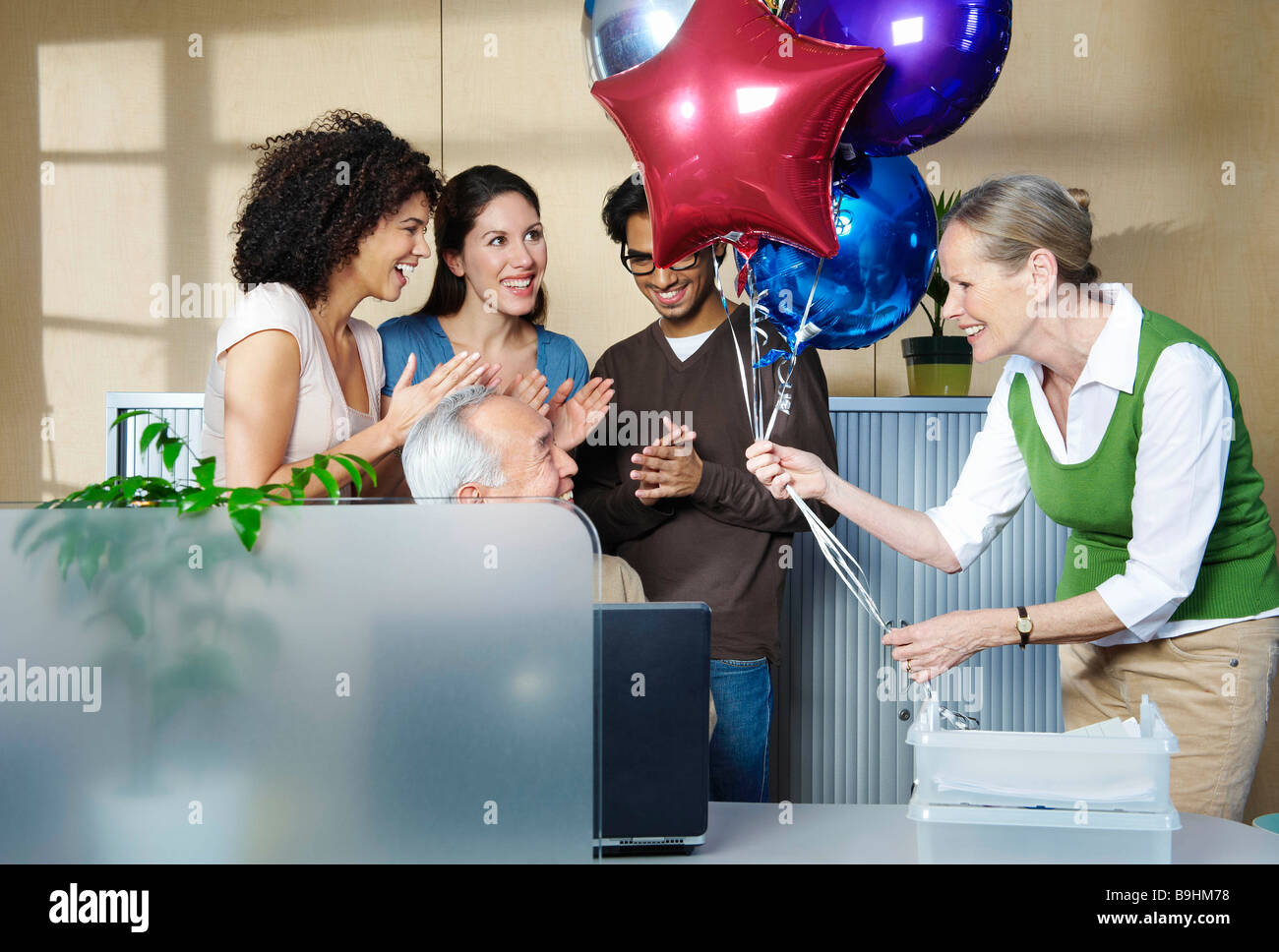 Group of people celebrating co-worker Stock Photo - Alamy