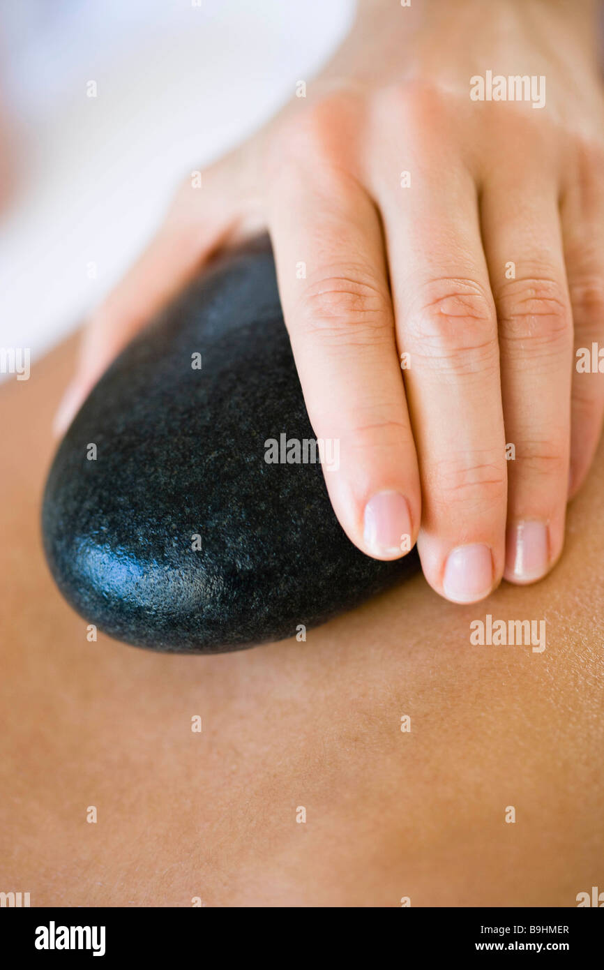 Hand holding hot stone Stock Photo - Alamy