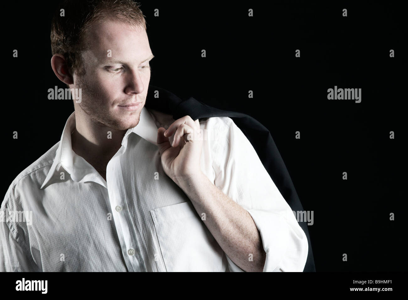 Portrait of a young man, jacket over his shoulder Stock Photo - Alamy