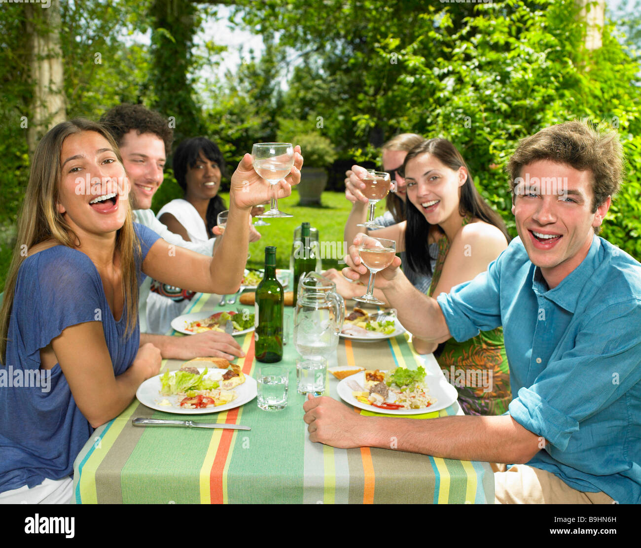 Friends having lunch in the garden Stock Photo - Alamy