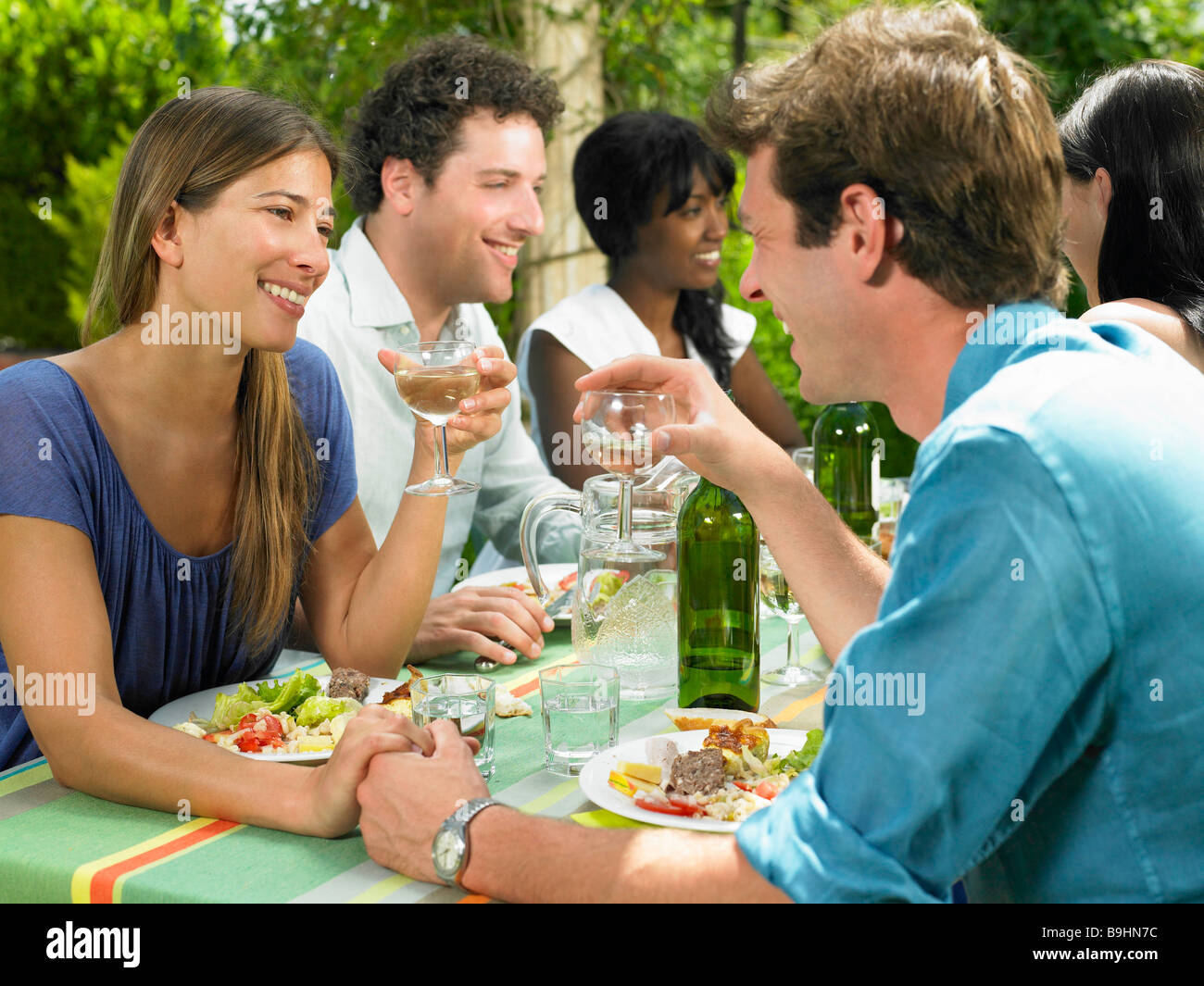 Friends having lunch in the garden Stock Photo - Alamy