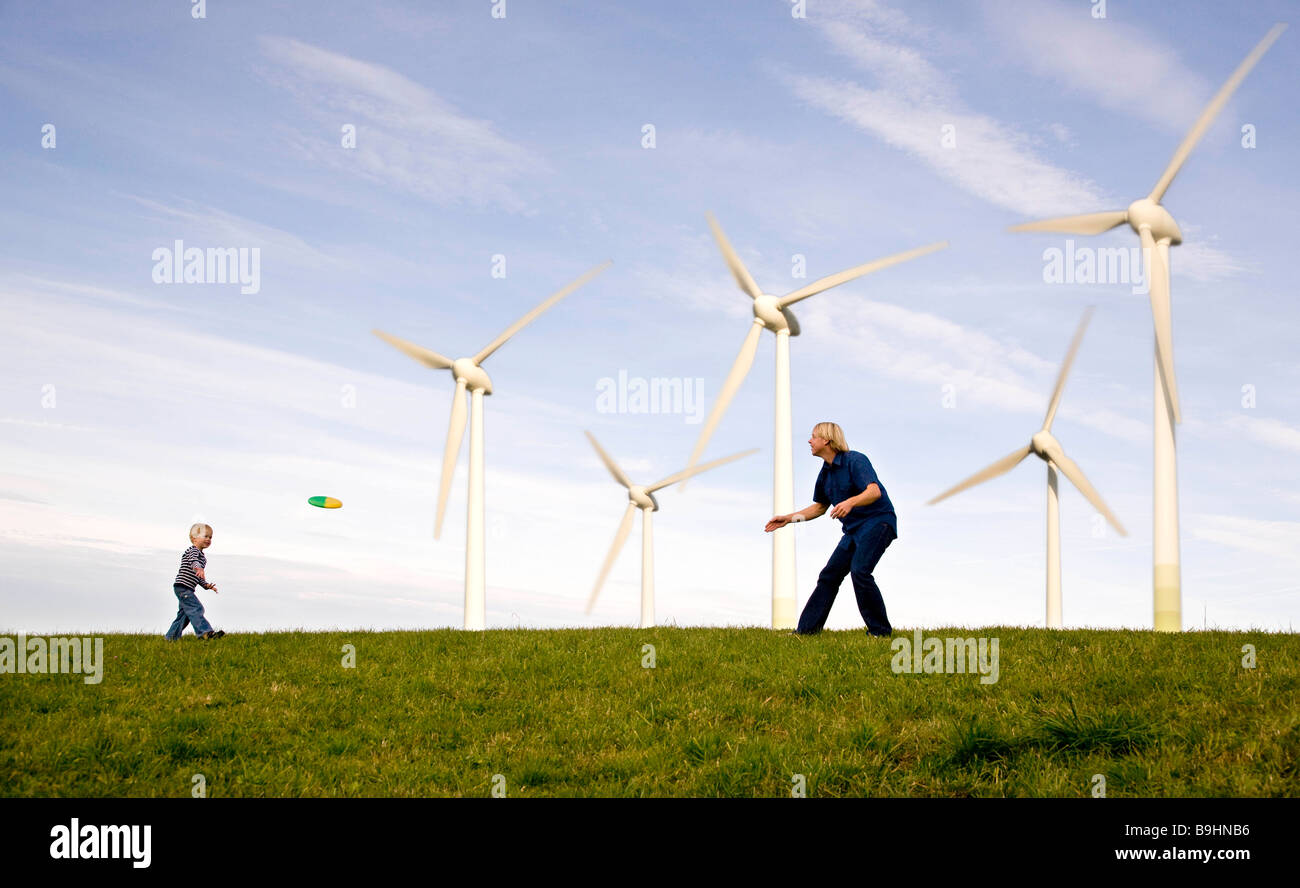 Man, boy play Frisbee at Wind Turbines Stock Photo - Alamy