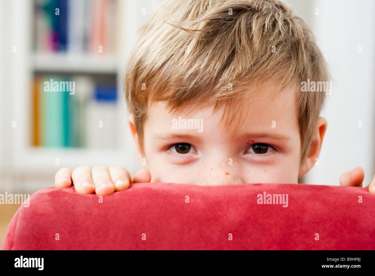 Young boy hiding Stock Photo - Alamy
