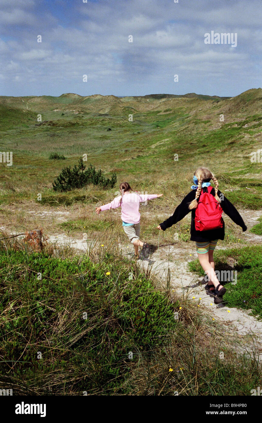 girl running way children two North Sea Stock Photo - Alamy
