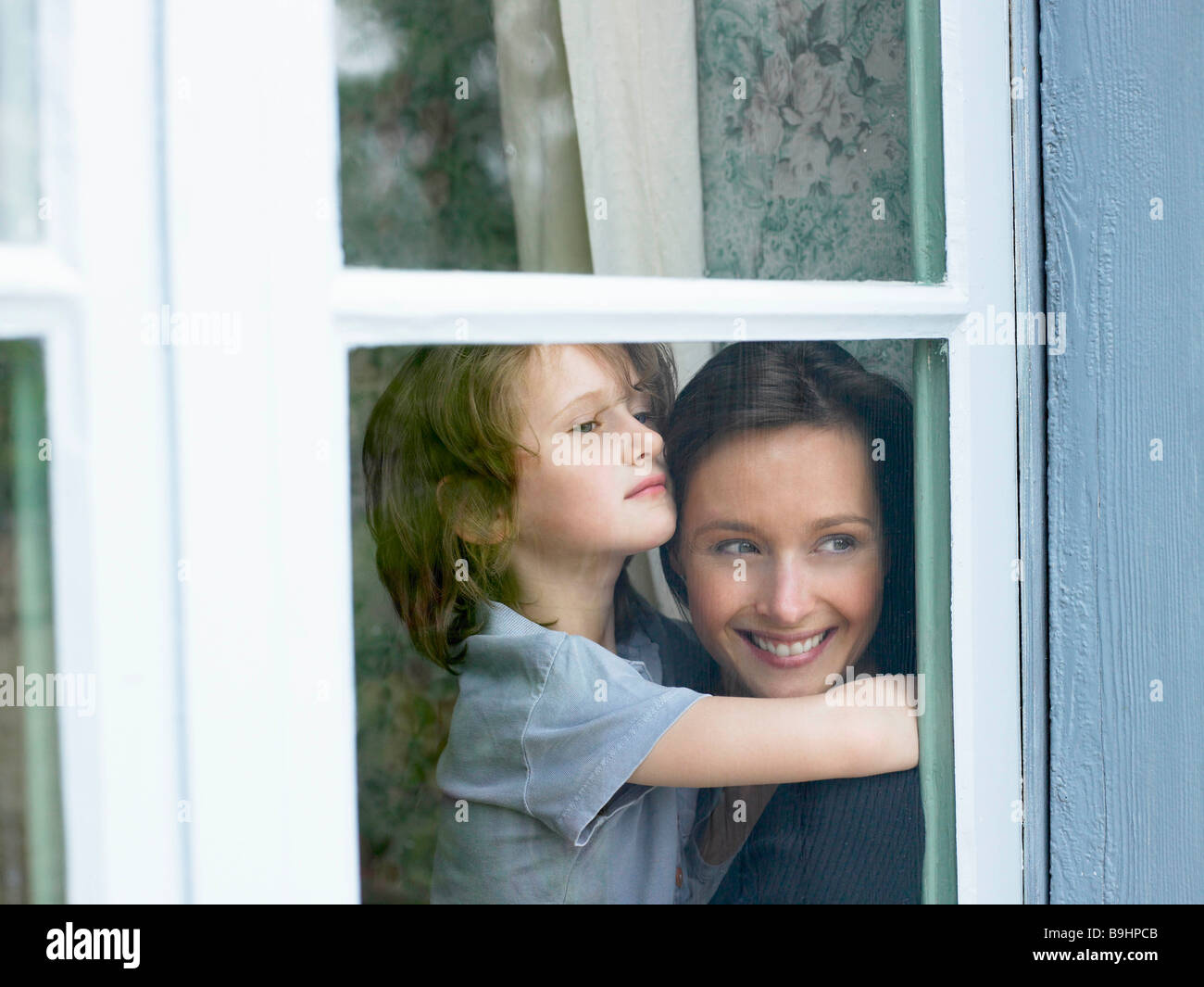 Mother and daughter behind window Stock Photo - Alamy