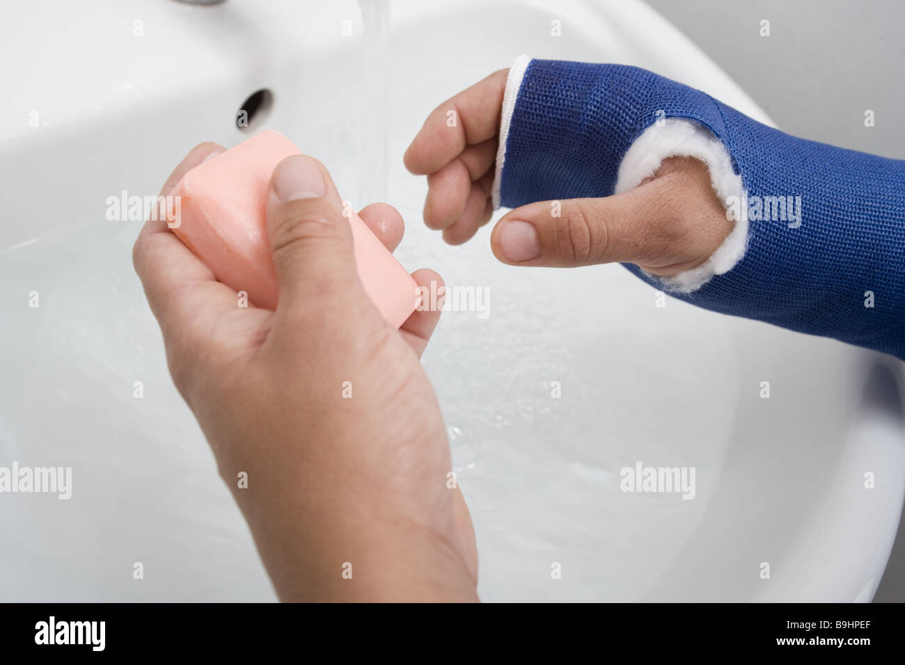 Man detail arm arm in plaster washes people soap hands series arm ...