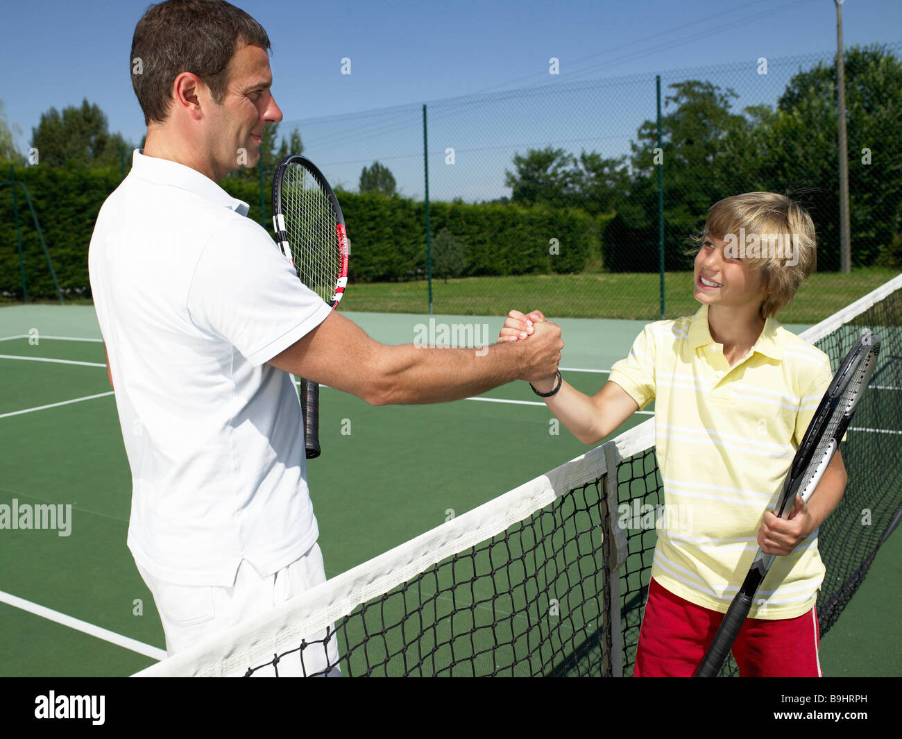 Tennis lesson under the heat Stock Photo - Alamy