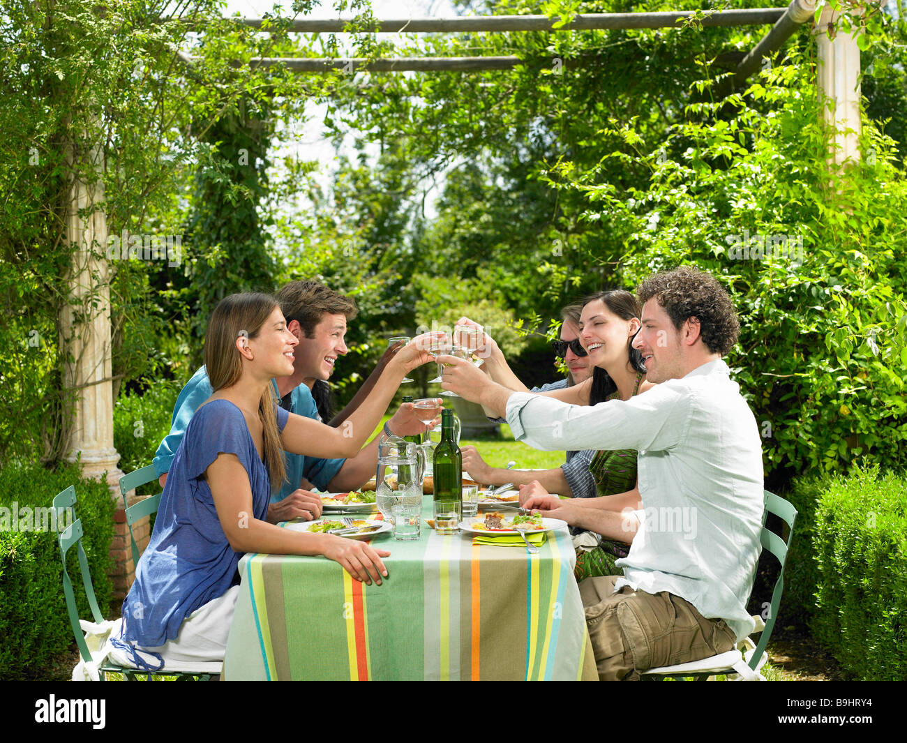 Friends having lunch in the garden Stock Photo - Alamy