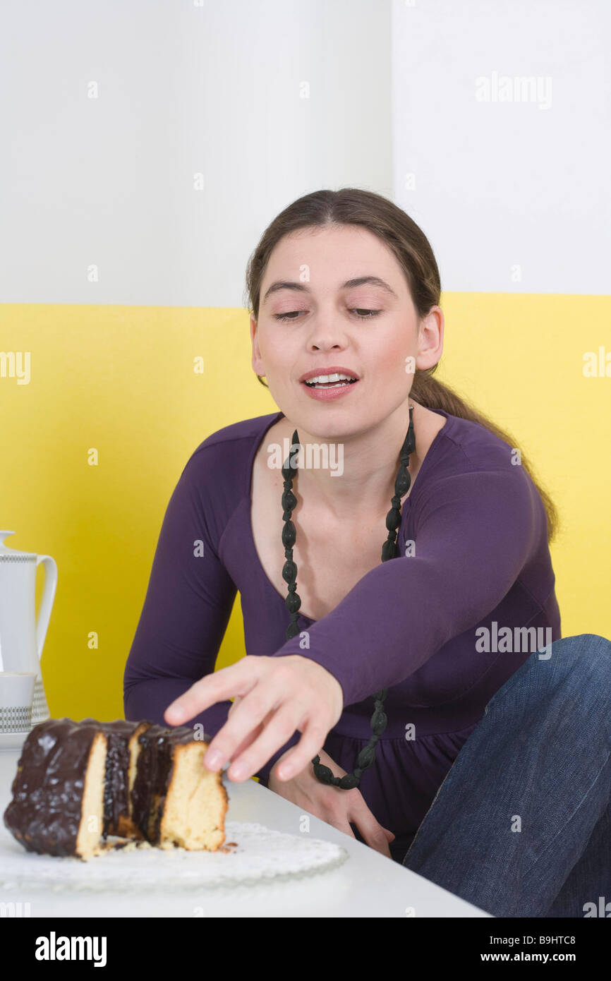 Reaching for cake woman hi-res stock photography and images - Alamy
