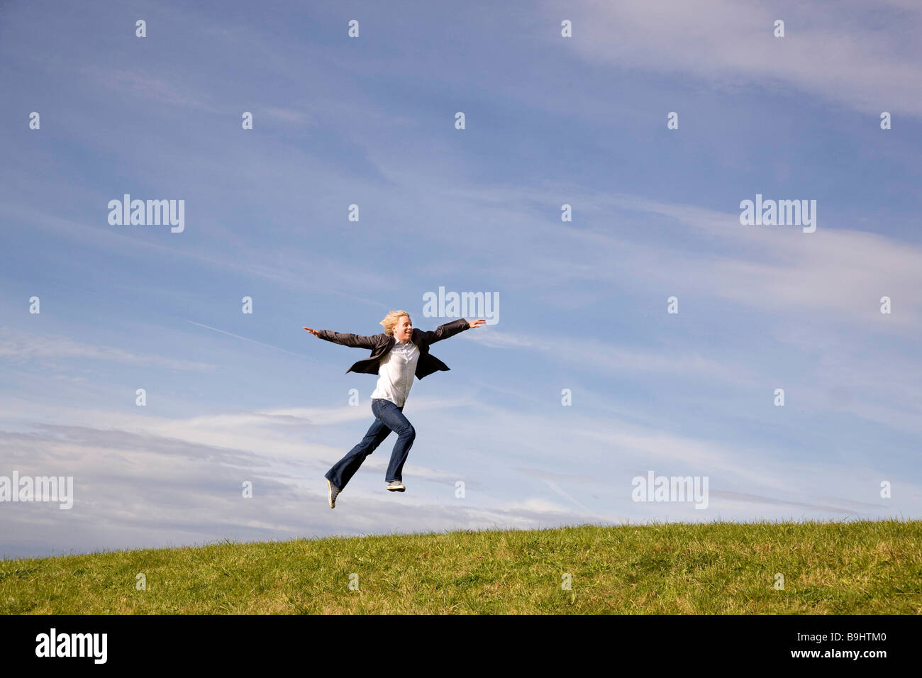 Man jumping on grass Stock Photo - Alamy