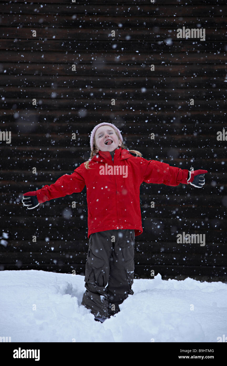Little girl catching snowflakes Stock Photo - Alamy