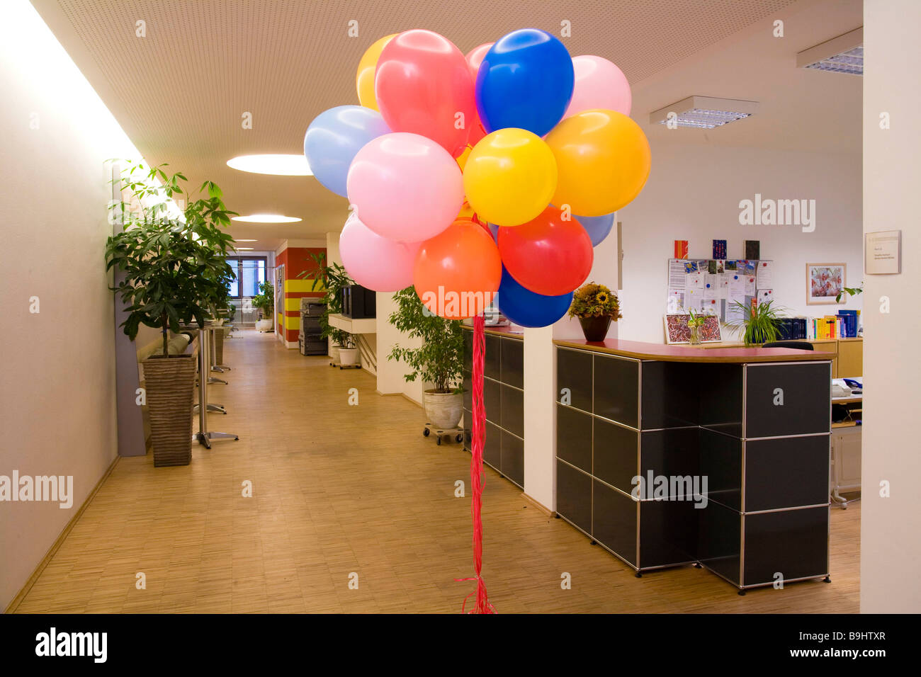Balloons in office Stock Photo - Alamy