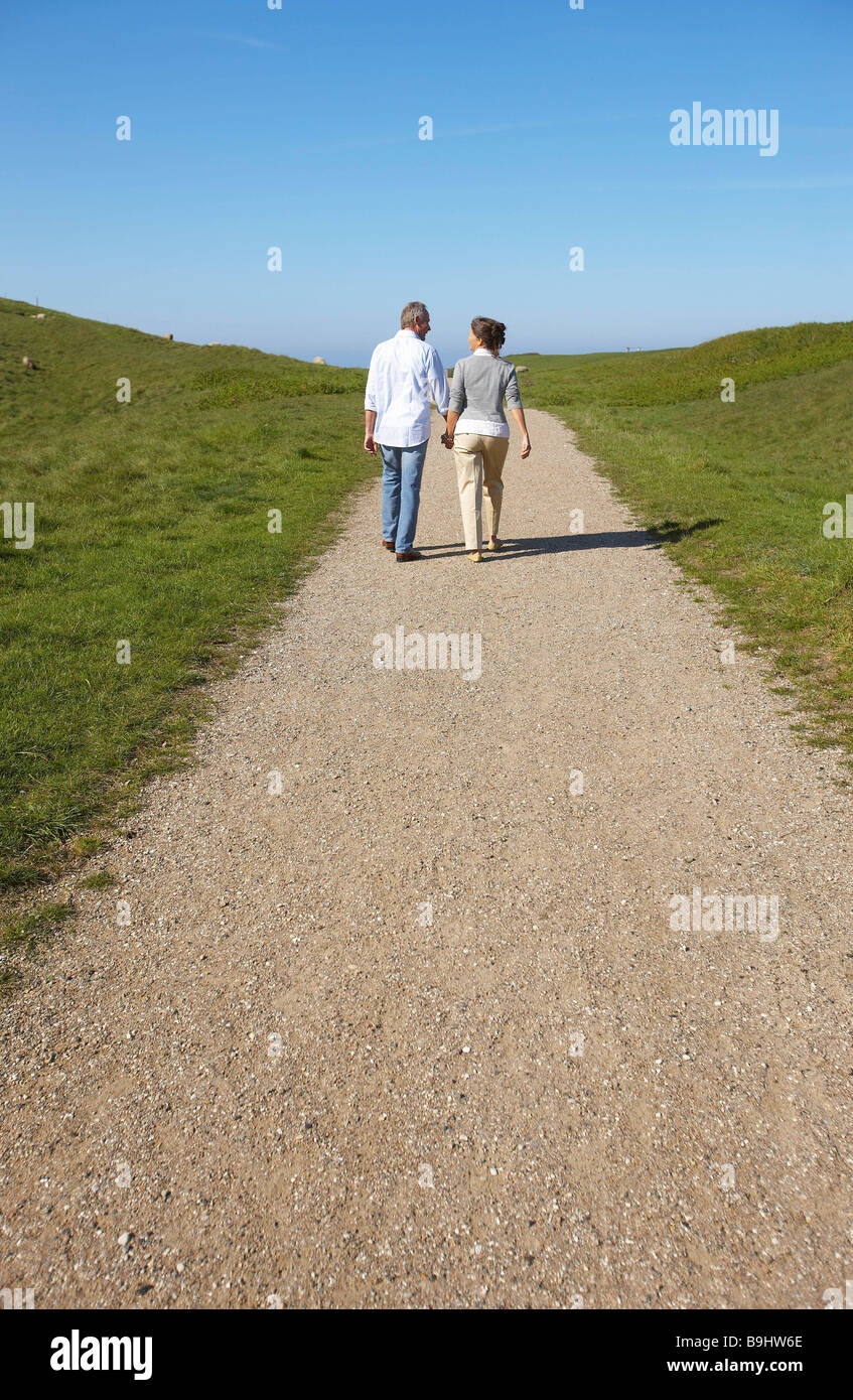 Mature couple walking away together Stock Photo - Alamy