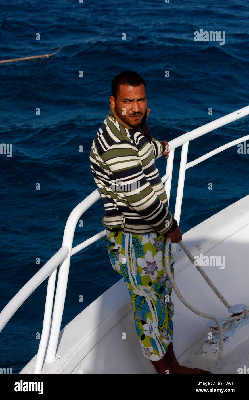 A sailor on a snorkelling boat off Hurghada on the Red Sea in Egypt ...