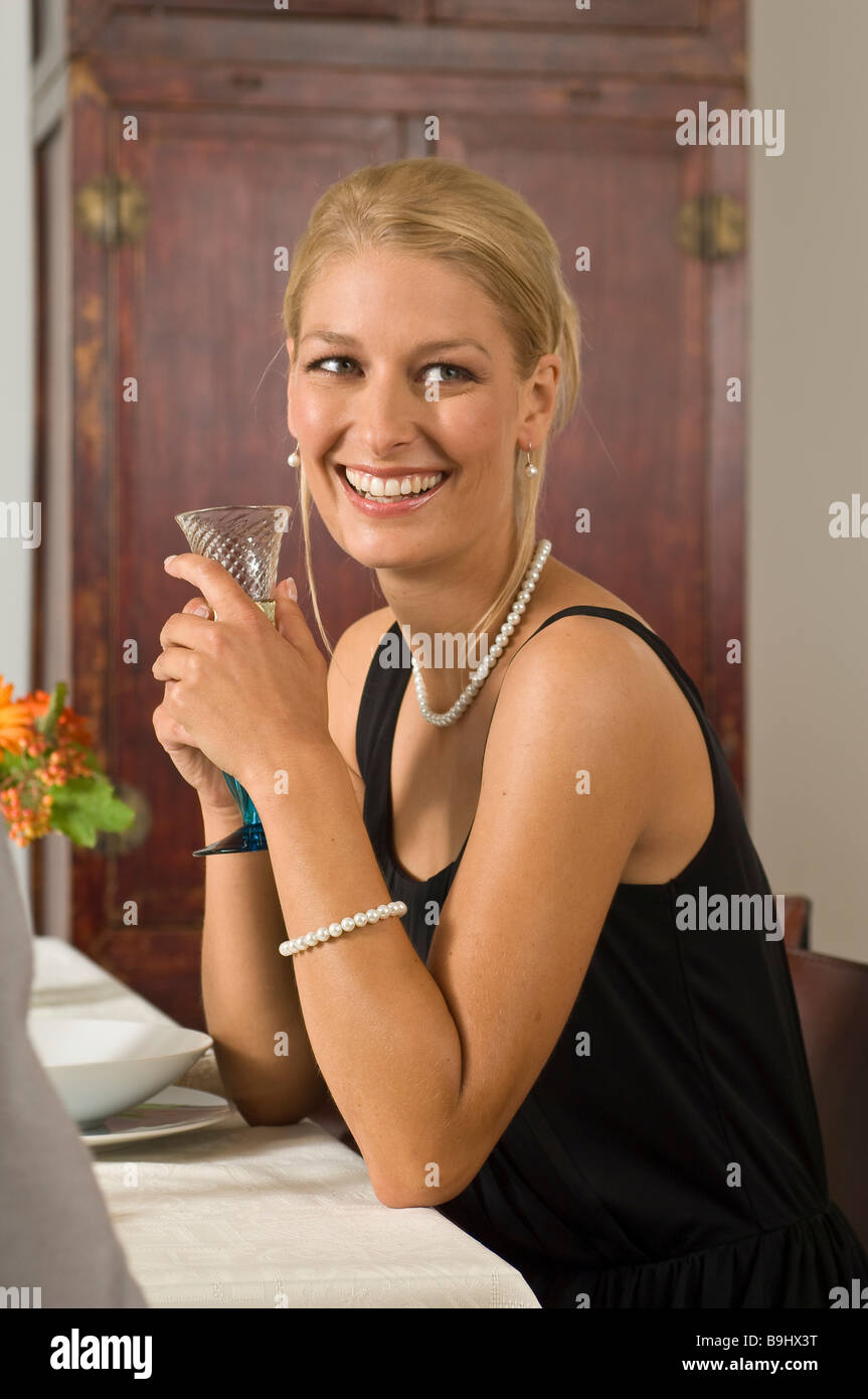 Festively dressed lady during a formal dinner in a solemn atmosphere ...