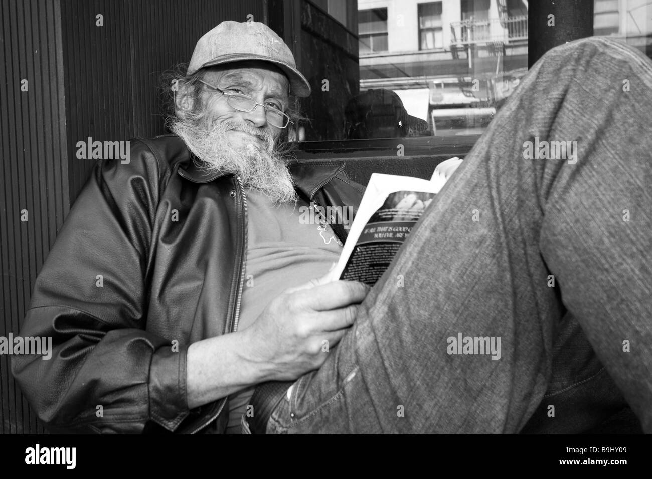 Portrait of an homeless man reading a book, San Francisco, California ...