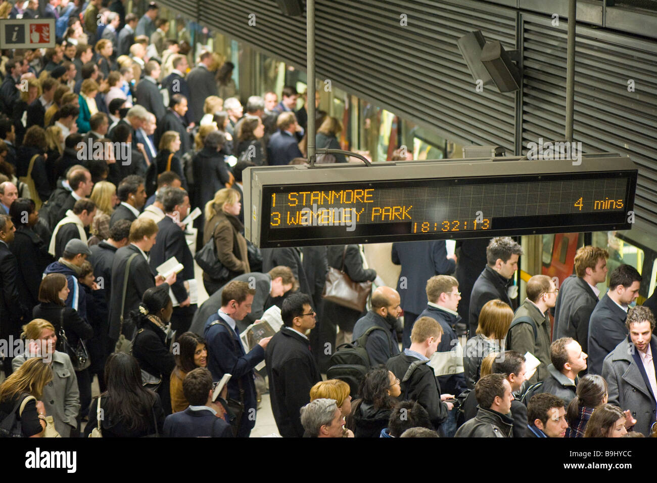 Commuters on crowded platform awaiting train Canary Wharf Docklands ...