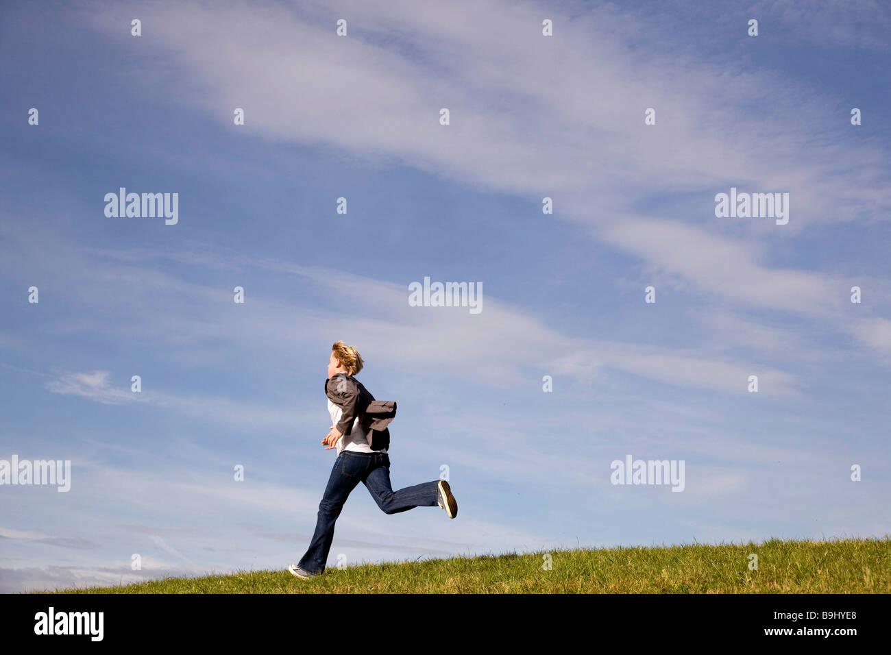 Man running on grass Stock Photo - Alamy