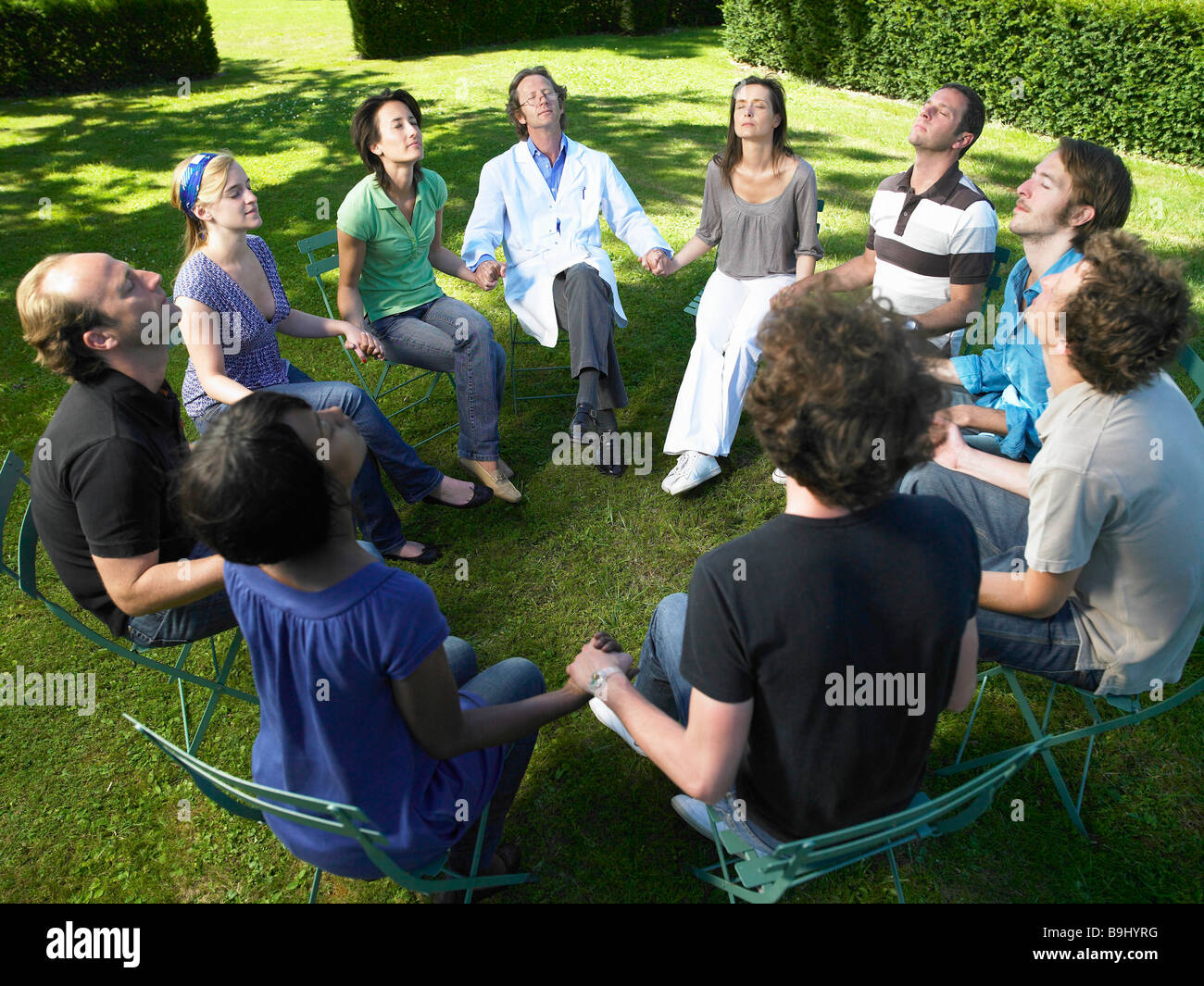 Circle of people in rehab, holding hands Stock Photo - Alamy