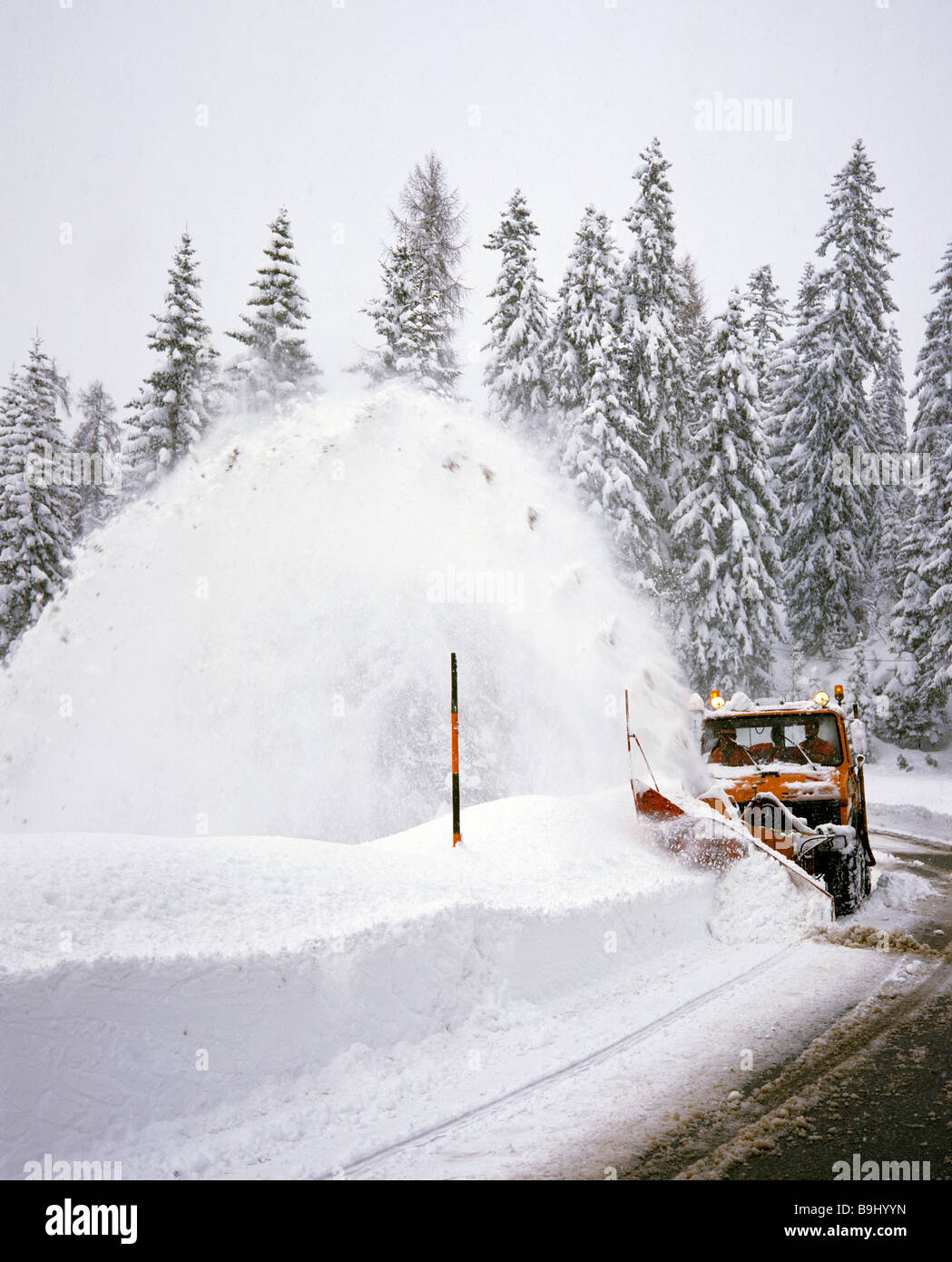 Snow-covered winter landscape, fresh snow, snow blower clearing snow ...