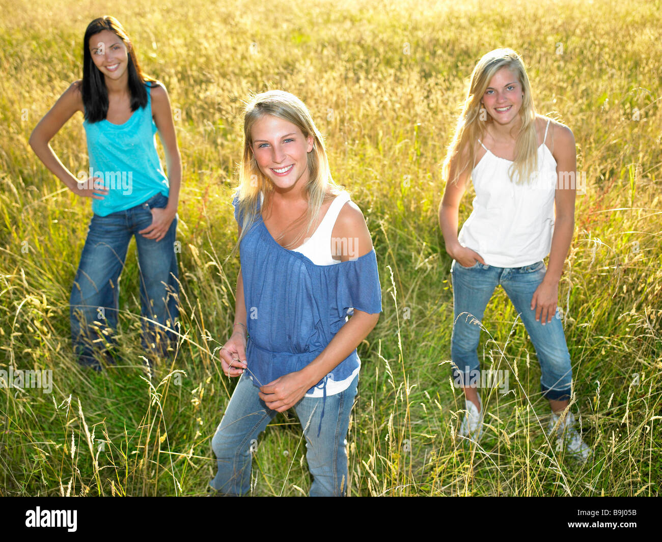 Women standing in a field, smiling Stock Photo - Alamy