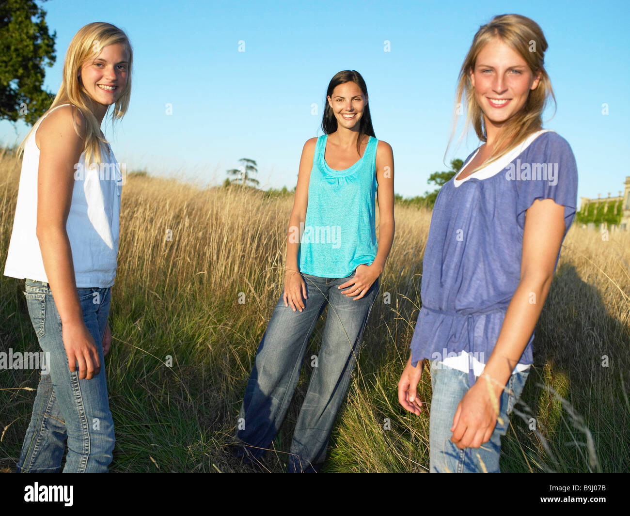 Girls in a field, smiling Stock Photo - Alamy