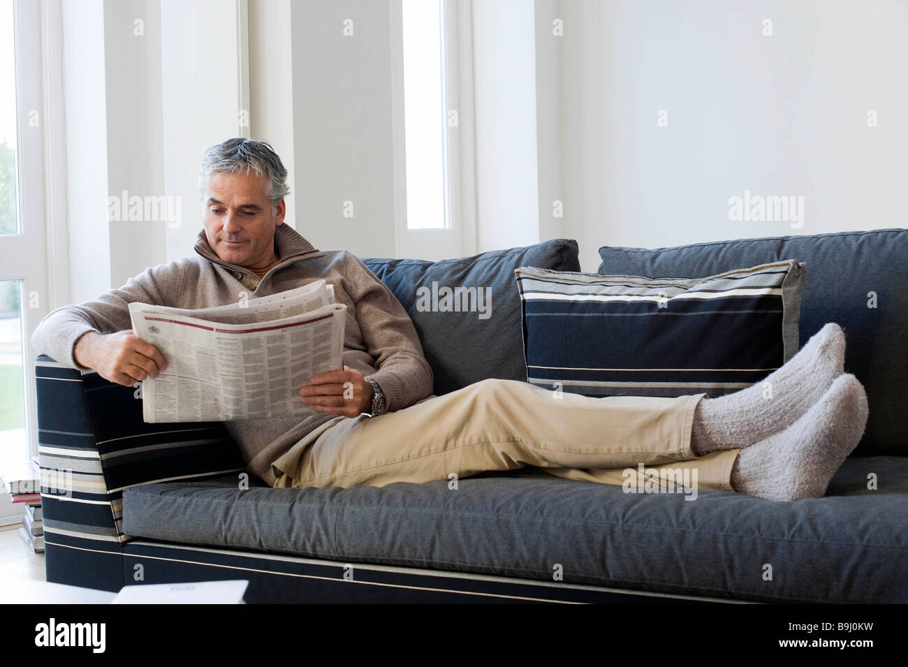 Man reading newspaper Stock Photo - Alamy