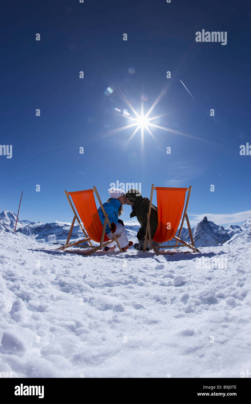 Couple kissing/reclining in deck chairs Stock Photo - Alamy