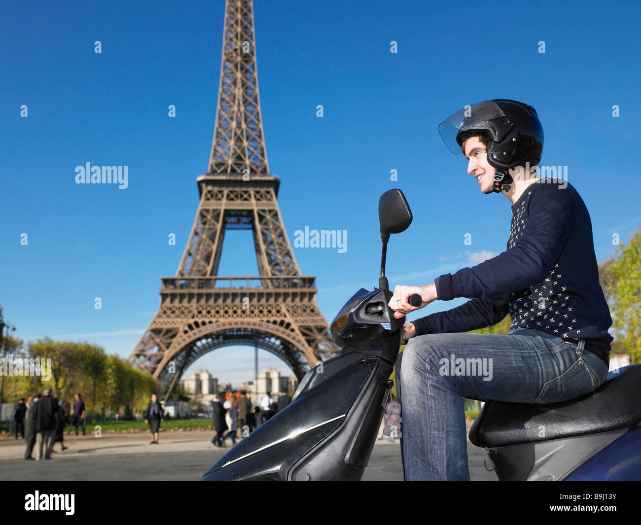 Man on moped in Paris Stock Photo - Alamy