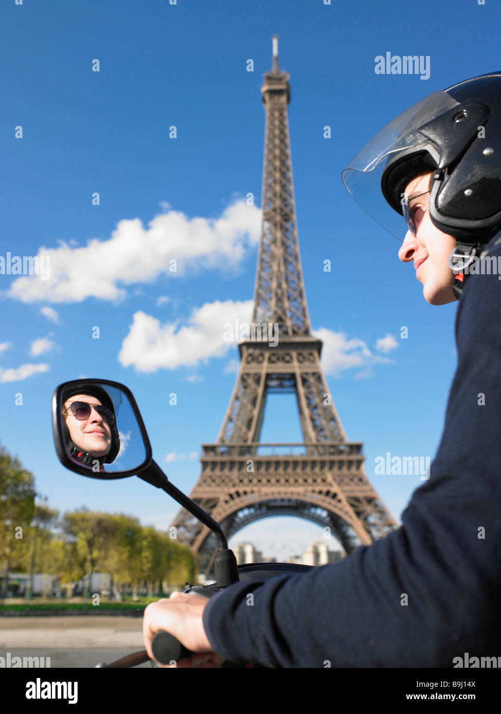 Man on moped in Paris Stock Photo - Alamy