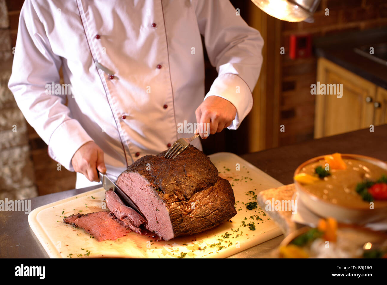 Chef slicing a roast Stock Photo - Alamy