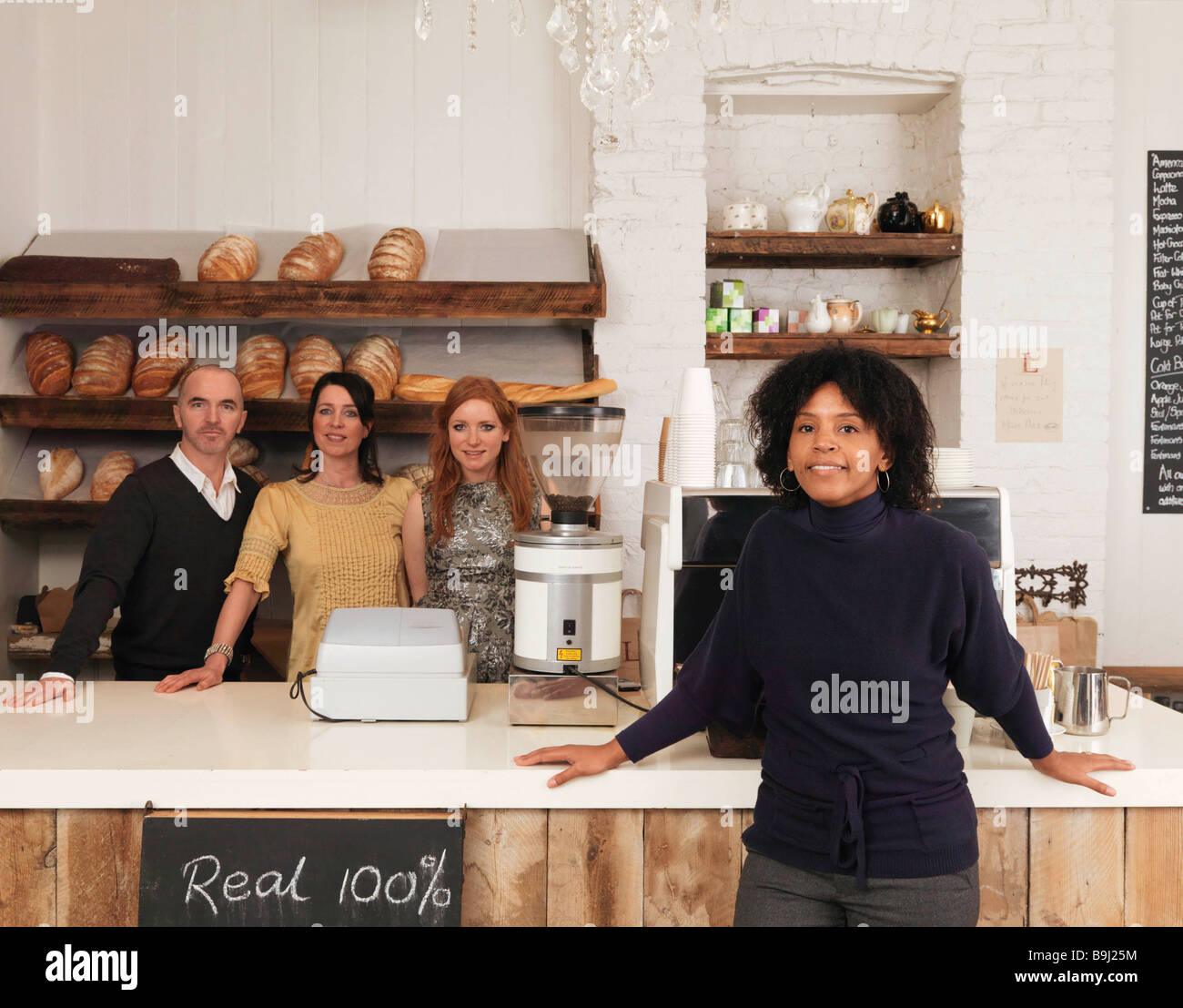 Business owner posing with employees Stock Photo - Alamy