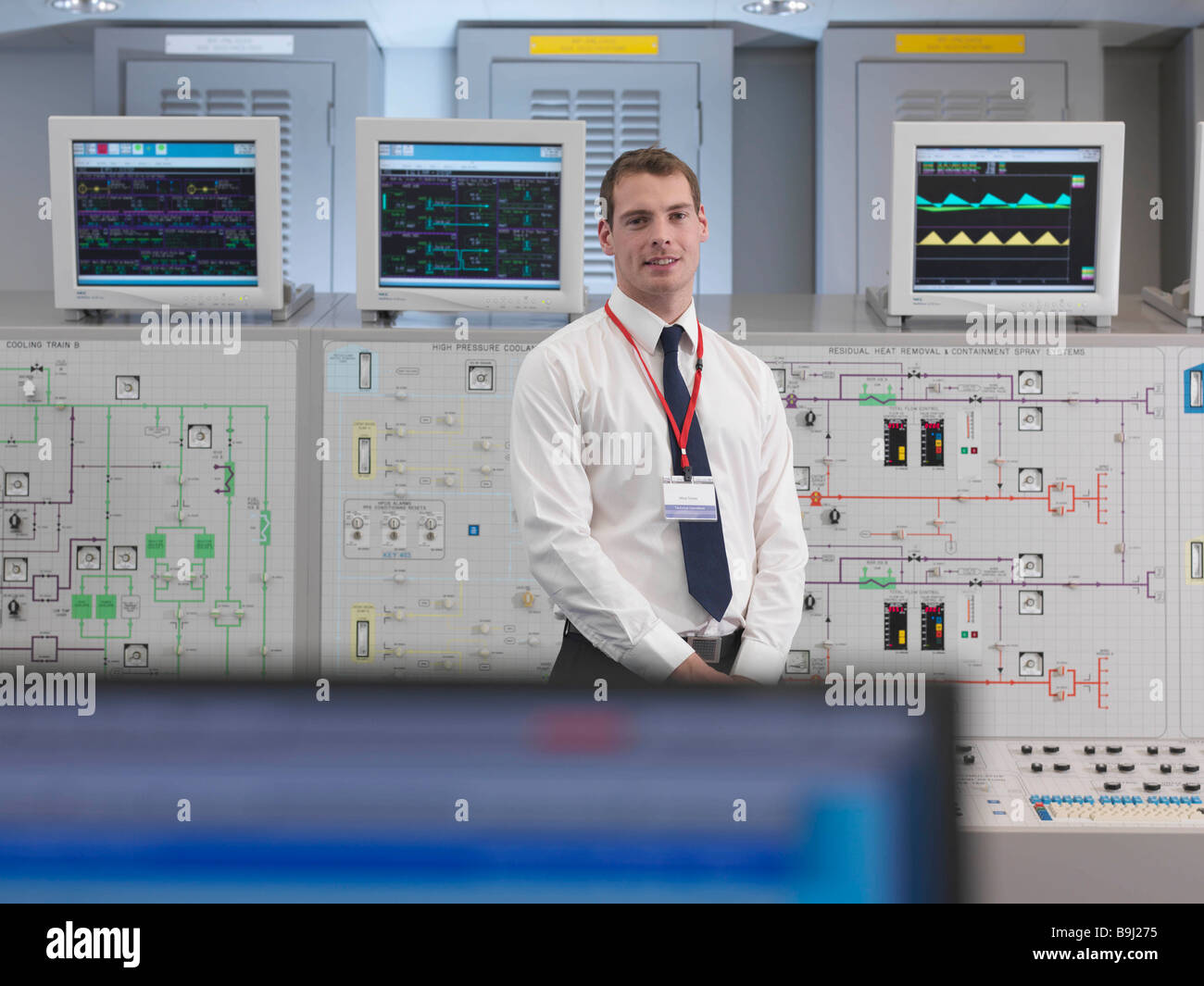 Operator with screens in control room Stock Photo - Alamy