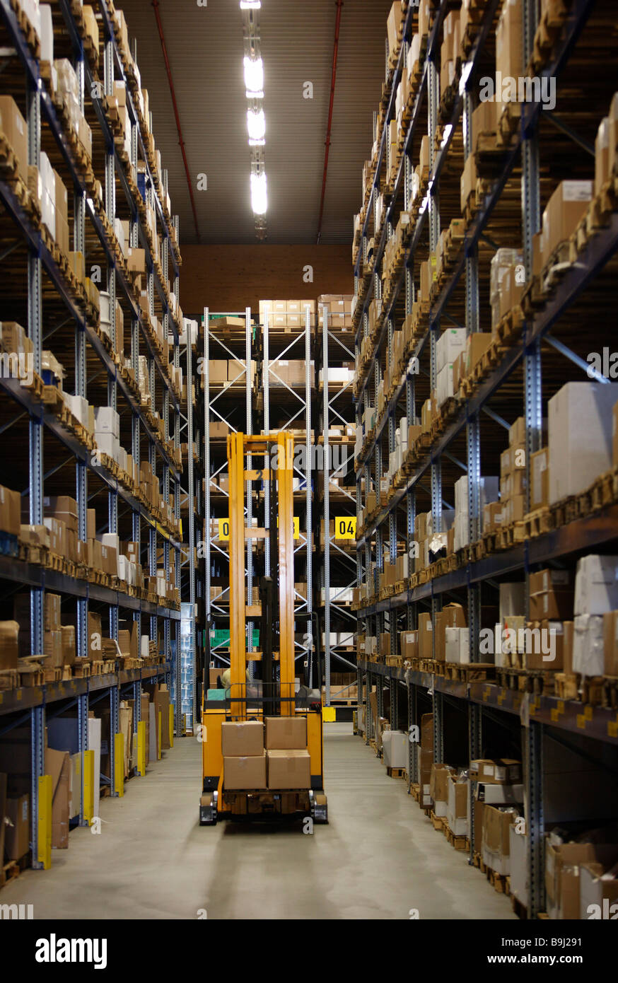 Warehouseman in a forklift truck bringing and collecting transport and ...