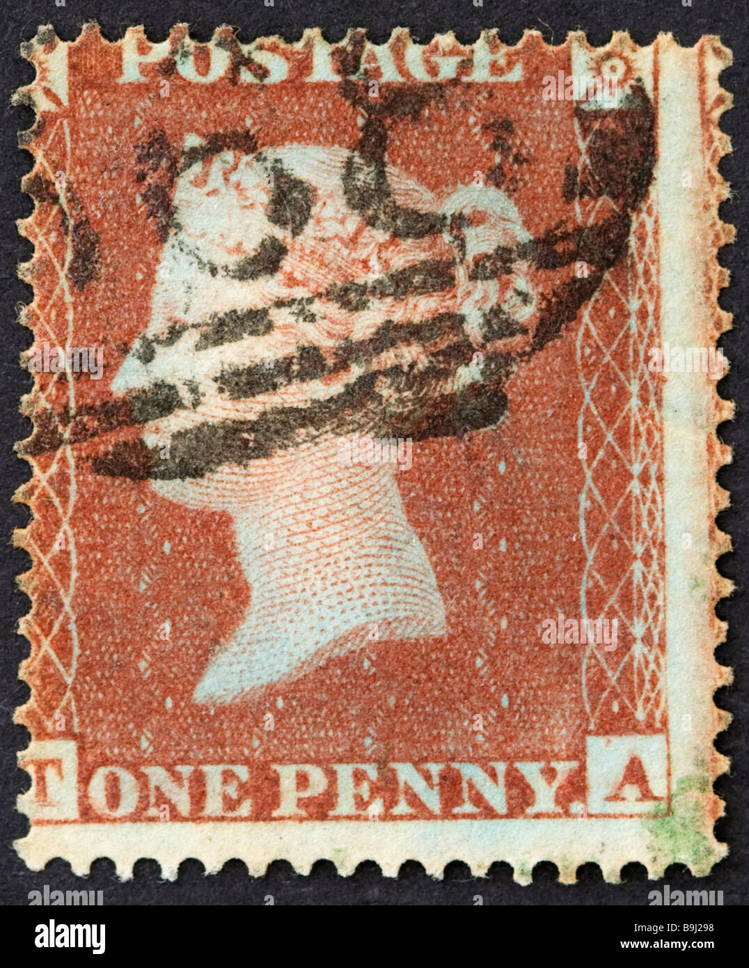 Close up of 1d red Victorian British Postal stamp on black background ...