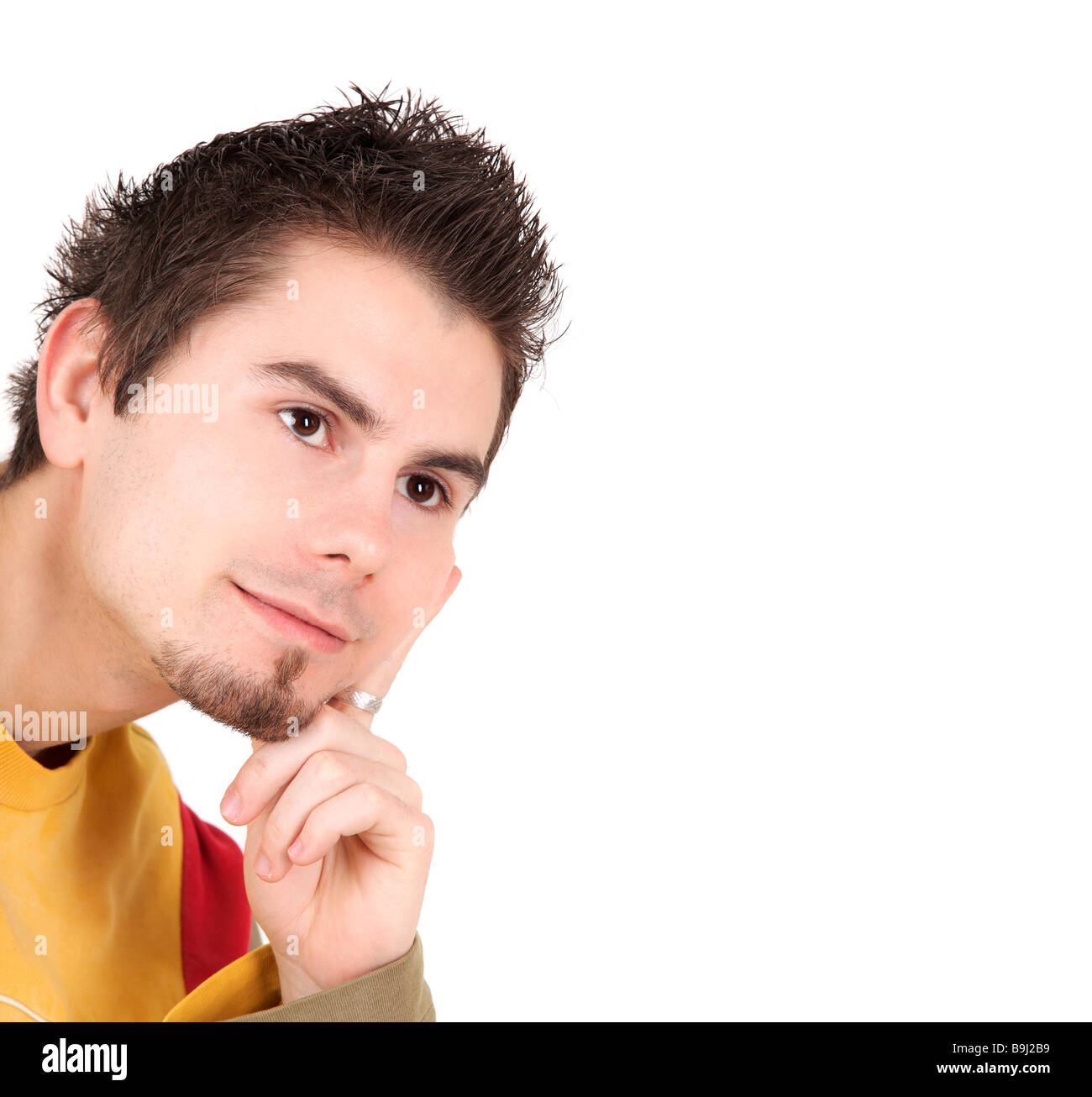 Portrait of young man thinking, studio shot Stock Photo - Alamy