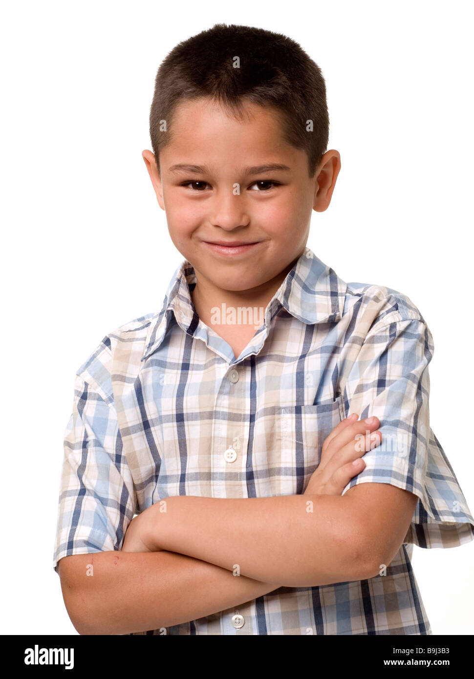 Portrait of a well dressed little boy in shirt with arms folded and ...