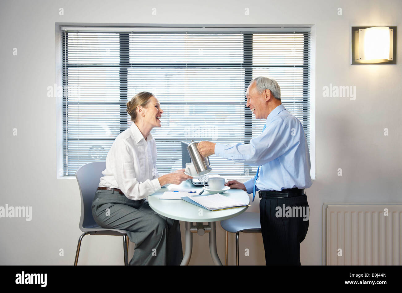 Woman pouring coffee meeting hi-res stock photography and images - Alamy